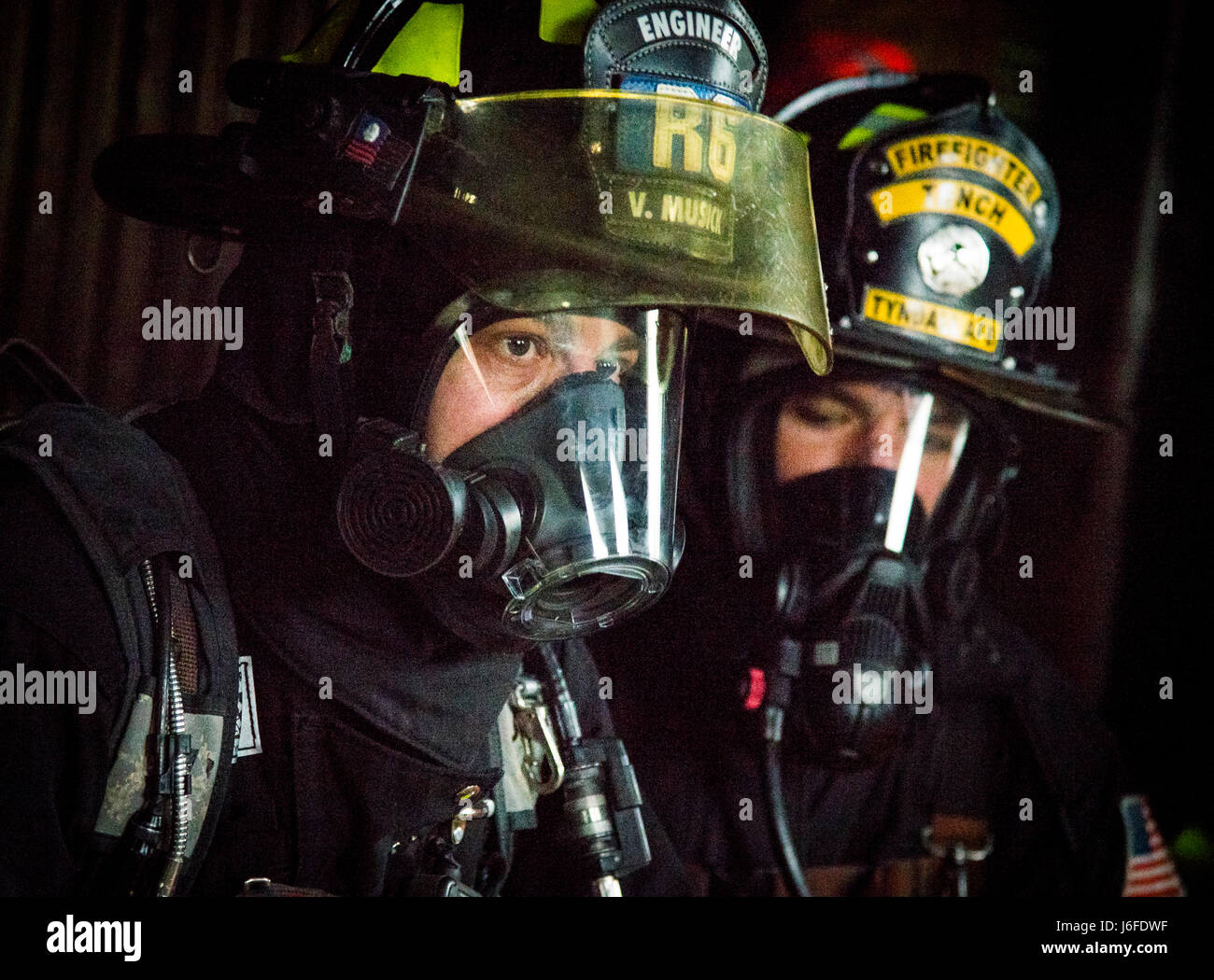 Firefighters wait to begin a live burn exercise during a “Know Your ...