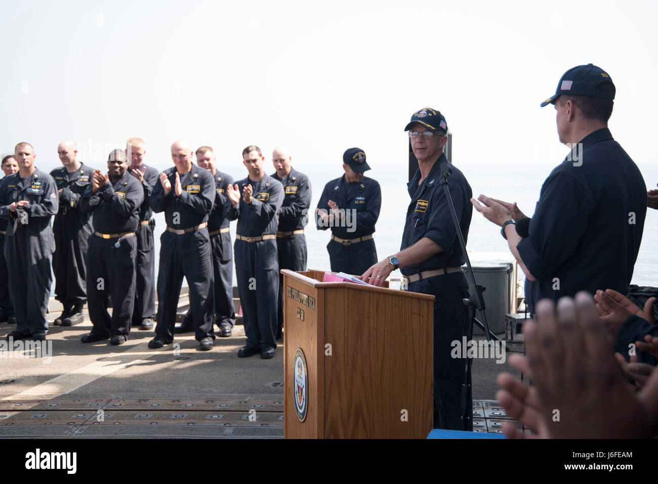 The crew of USS Philippine Sea (CG 58) conduct an all-hands call while ...