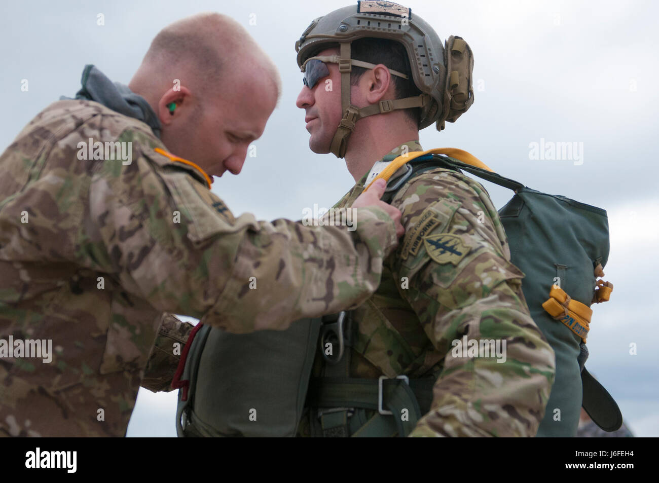 U.S. Army Staff Sgt. Matthew Thomas (left) performs parachute ...