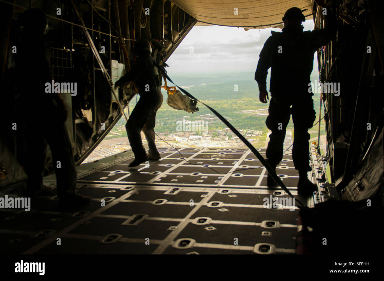 U.S. Air Force loadmasters pull in deployment bags back into a C-130 ...