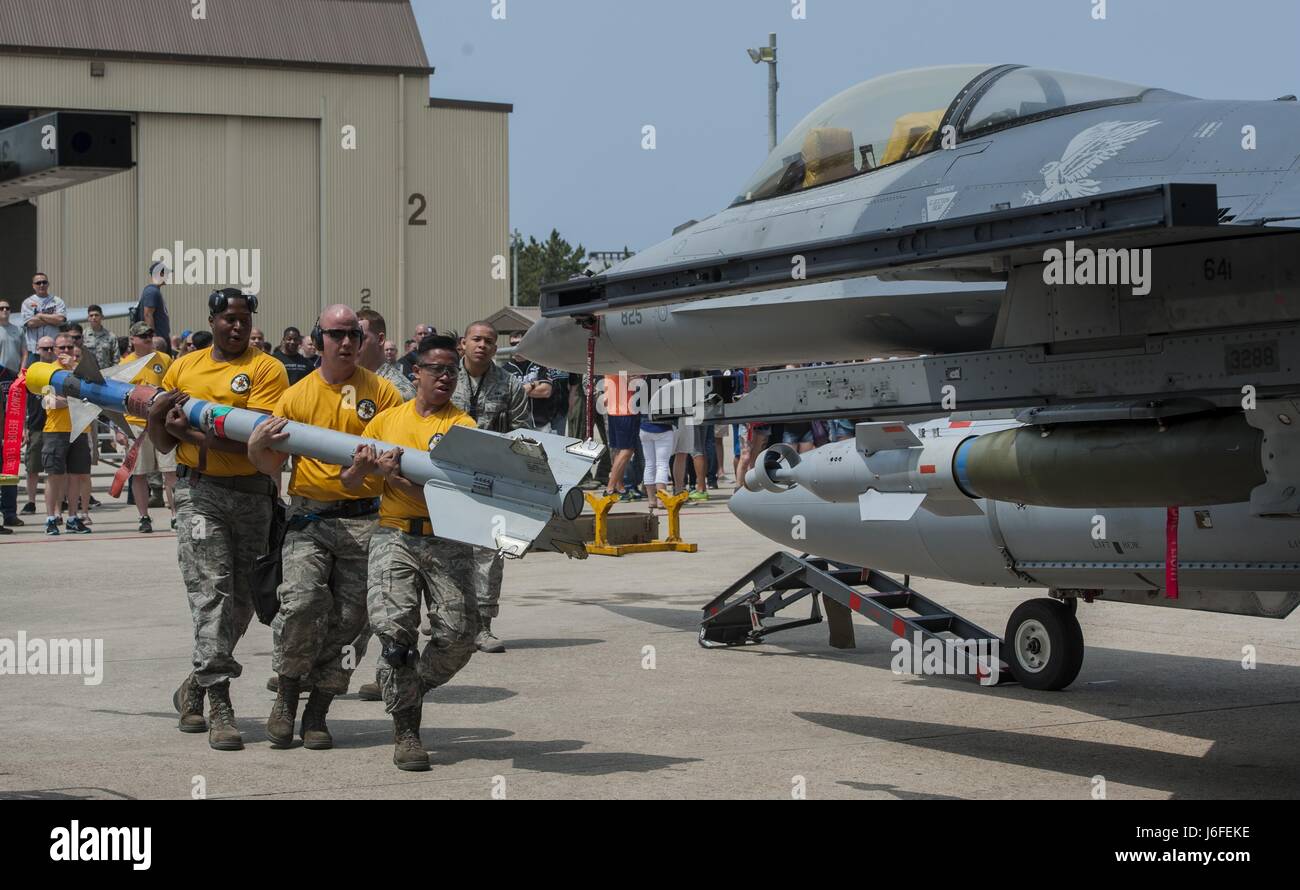 U.S. Air Force load crew members from Misawa Air Base carry a bomb ...