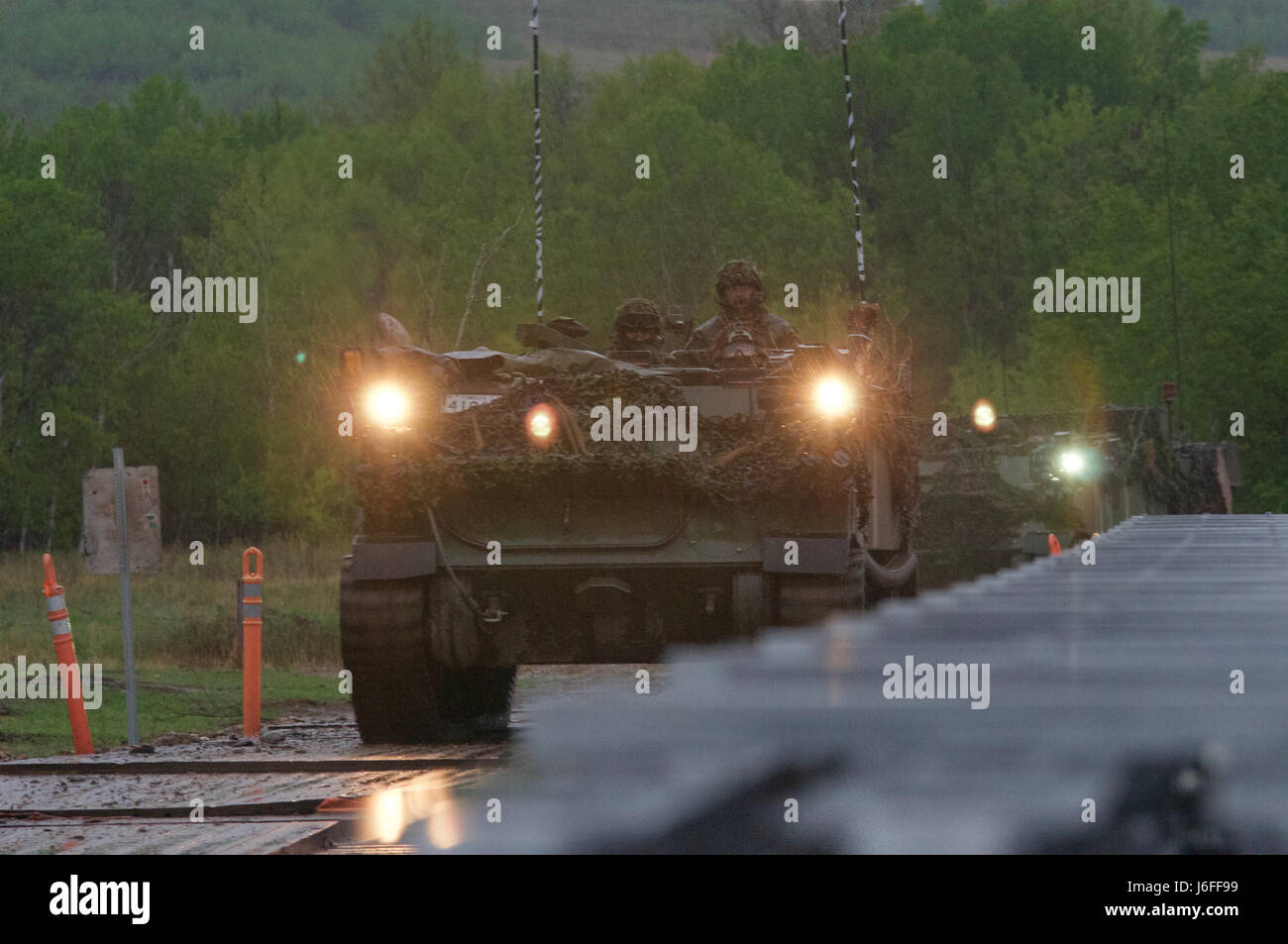 Canadian soldiers of the 2nd Canadian Mechanized Brigade Group move a ...