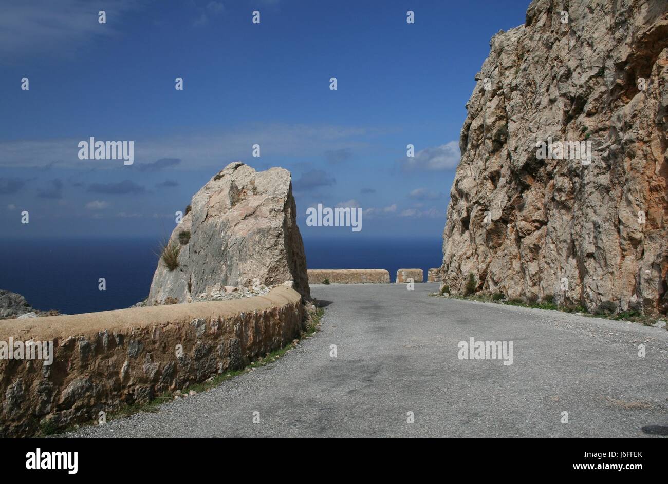 rock asphalt track bend serpentine path way salt water sea ocean water ...