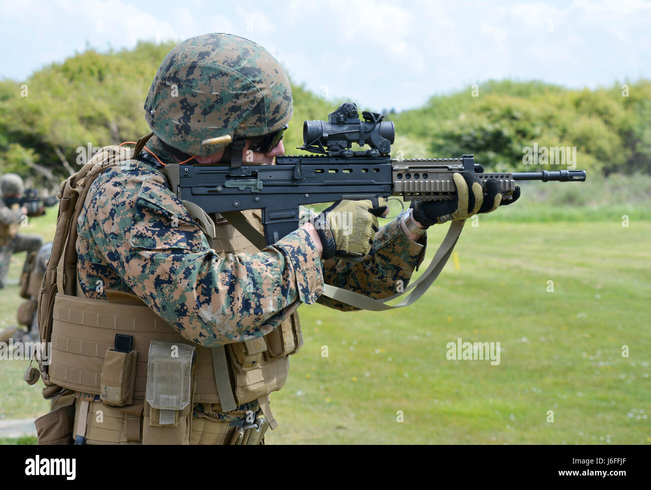 A U.S. Marine fires an SA80 A2 L85 Assault Rifle at Altcar Training ...