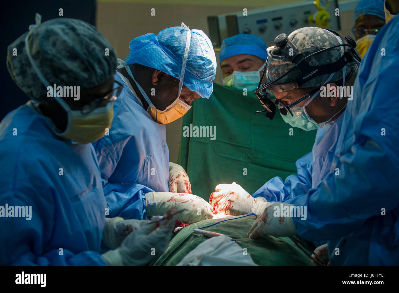 Chadian and U.S. Army Reserve surgeons perform a thyroidectomy during ...