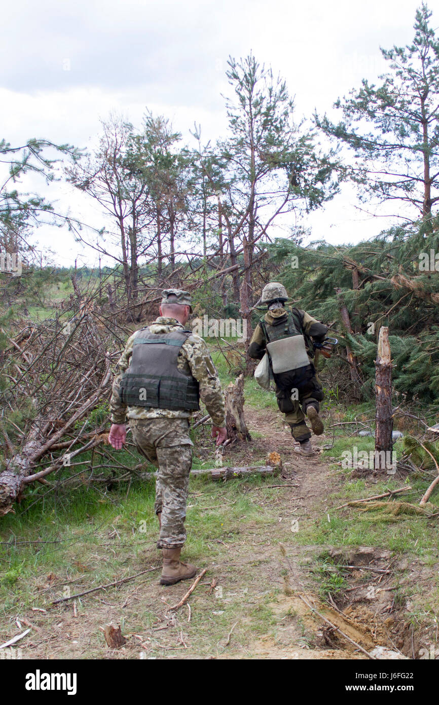 A Yavoriv Combat Training Center trainer observes and coaches a ...