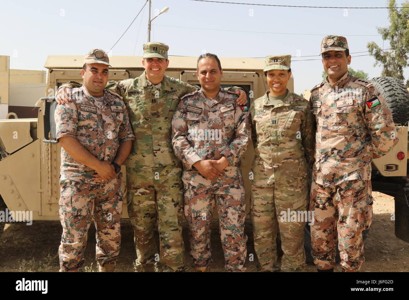 Jordanian and U.S. Army Central Soldiers stand in front of a Humvee ...