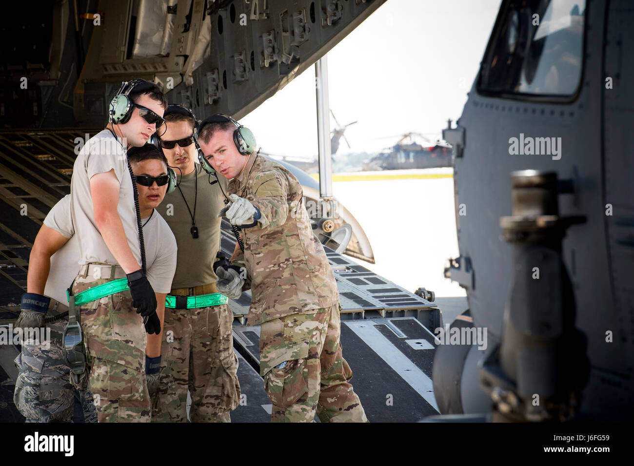 Airmen from the 41st Helicopter Maintenance Unit discuss procedure for ...