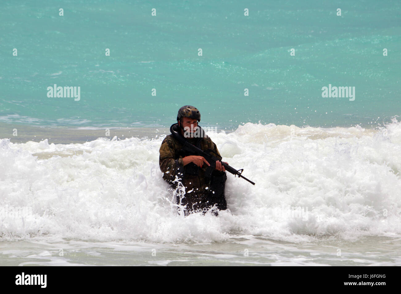 An infantryman conducts a helocast insertion onto a beach at Marine ...