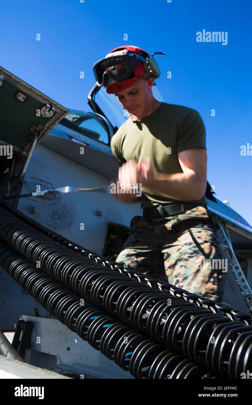 U.S. Marines with Marine Fighter Attack Squadron (VMFA) 232, load an F ...