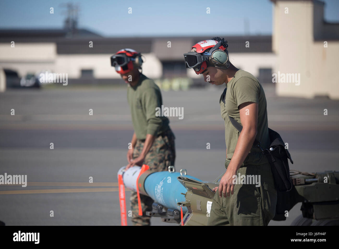 U.S. Marines with Marine Fighter Attack Squadron (VMFA) 232, load an F ...