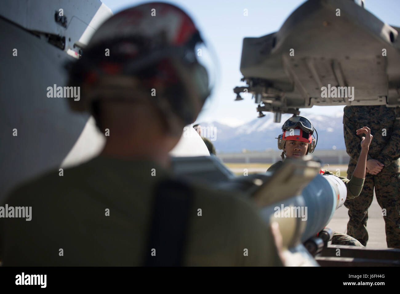 U.S. Marines with Marine Fighter Attack Squadron (VMFA) 232, load an F ...