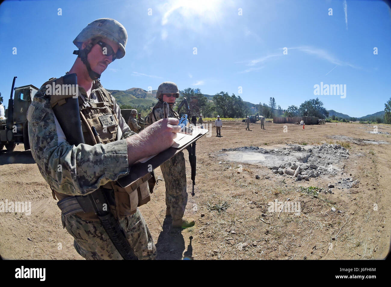 A Naval Mobile Construction Battalion 4 builder documents crater and ...