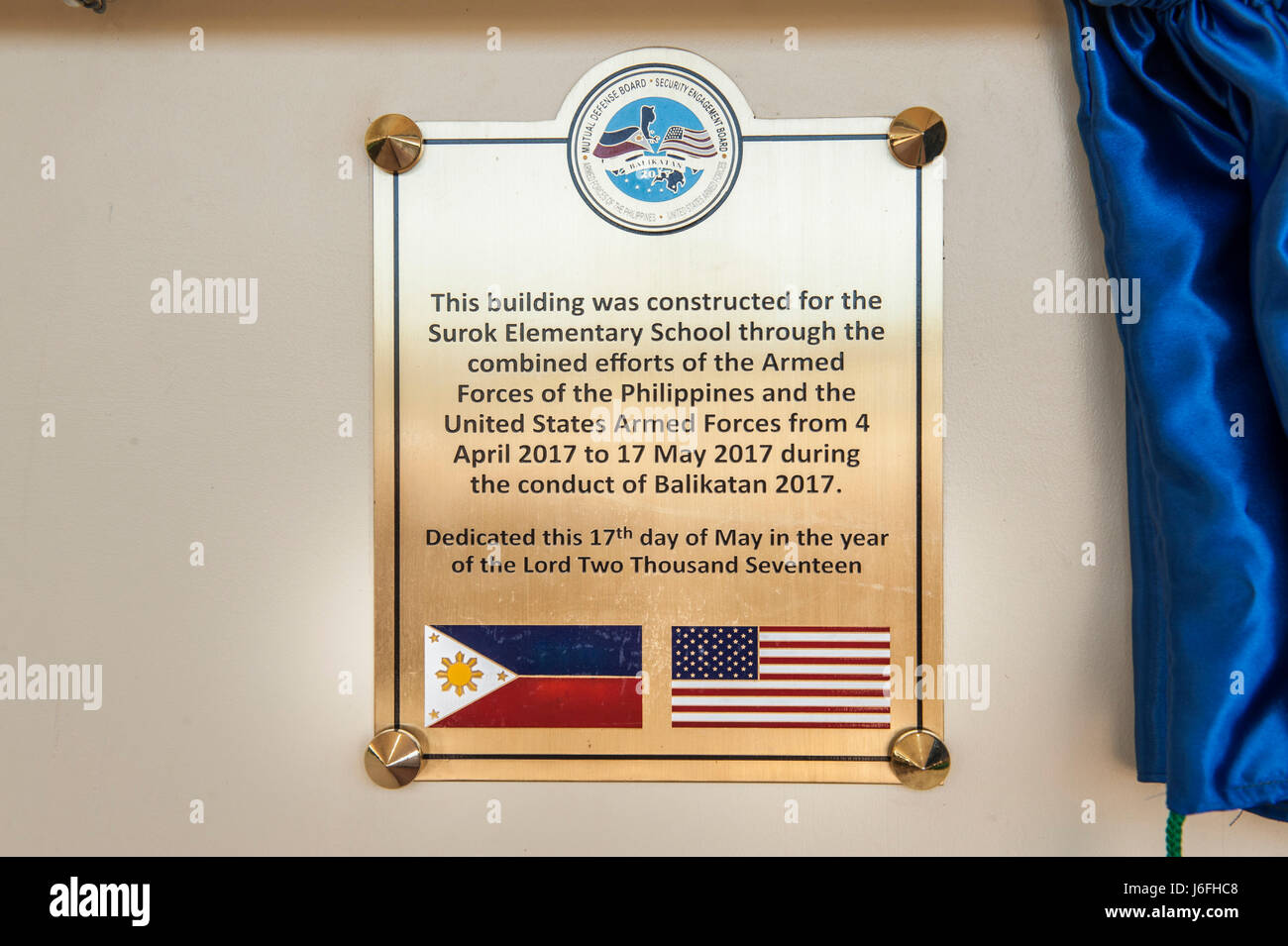 The official plaque hangs at the newly-built classroom at Surok ...