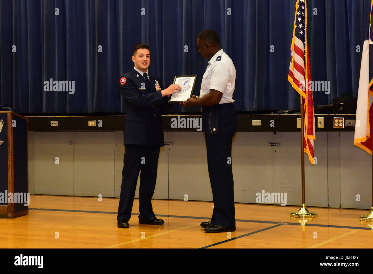 Cadet Col. Carlos Perez presents a certificate to Col. James Grace ...