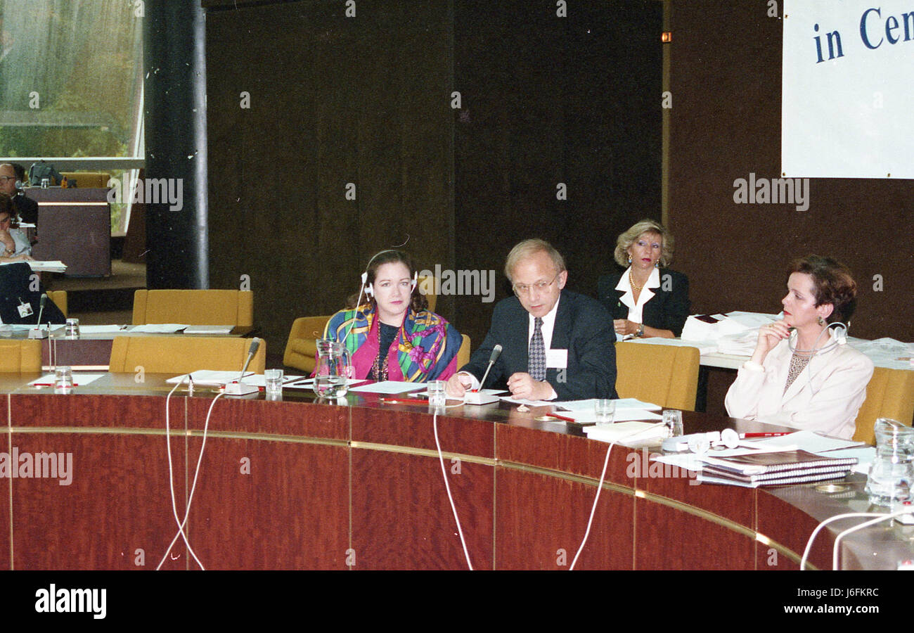A GROUP OF MEN AND WOMEN SITTING ON THE PANEL WHICH THEY ARE HAVING A ...