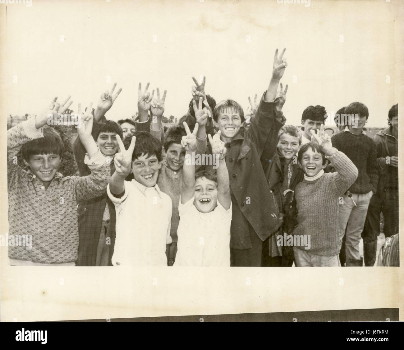 Children stand together taking a photograph, capturing a moment during ...