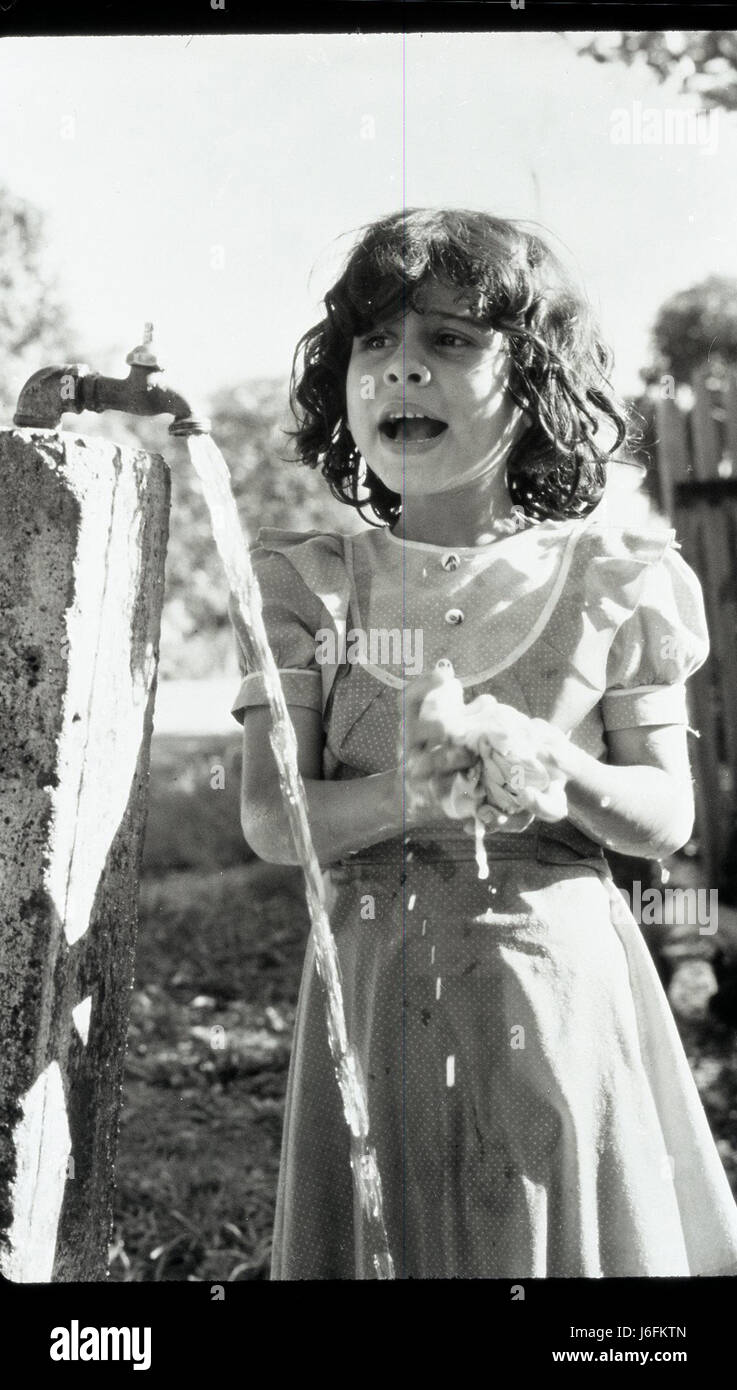 A LITTLE GIRL AT THE WATER WELL WASHING HER HANDS Stock Photo - Alamy