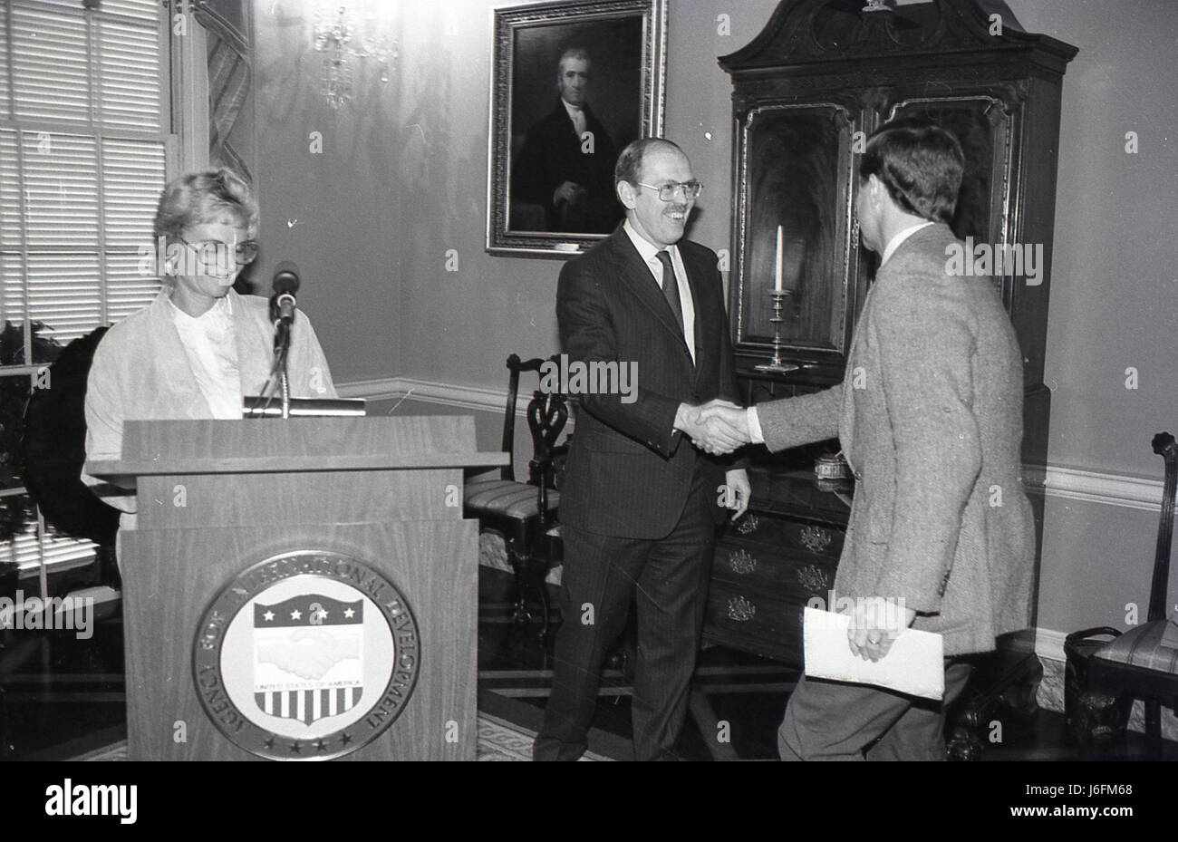 MAN GREETING ANOTHER MAN WITH A WOMEN AT THE PODIUM Stock Photo - Alamy