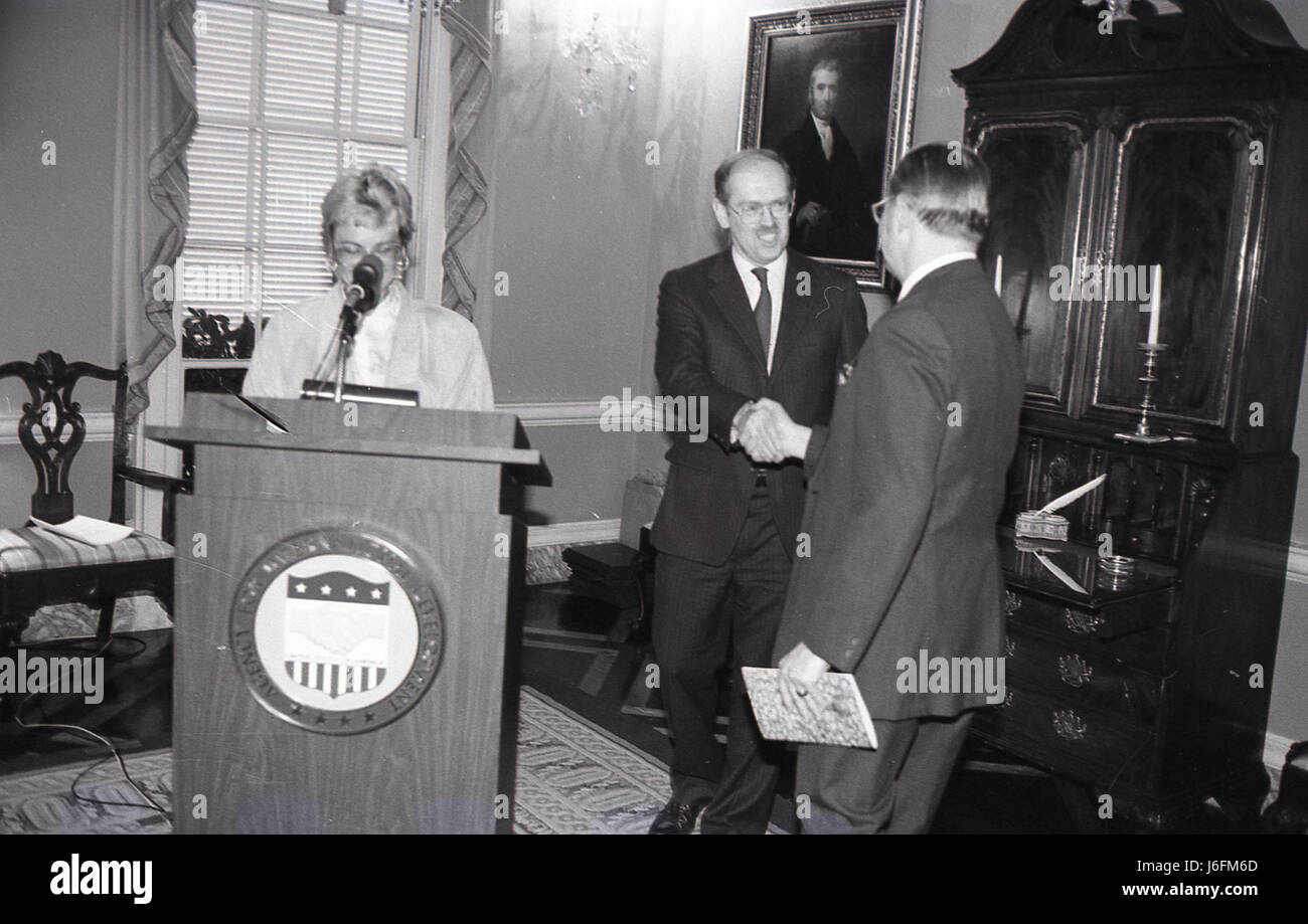 MAN GREETING ANOTHER MAN WITH A WOMEN AT THE PODIUM Stock Photo - Alamy