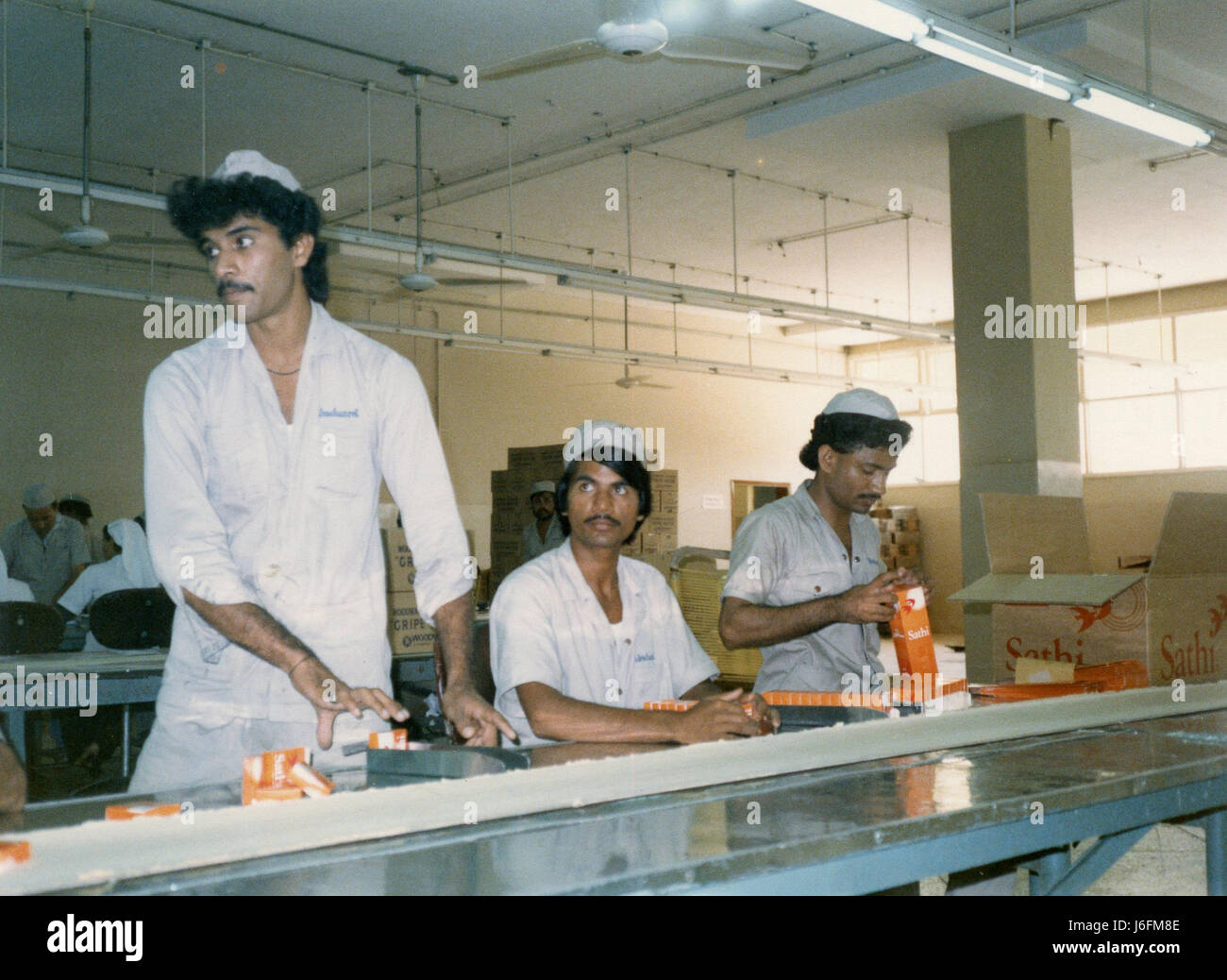 Three men are working on an assembly line at the Woodward factory ...