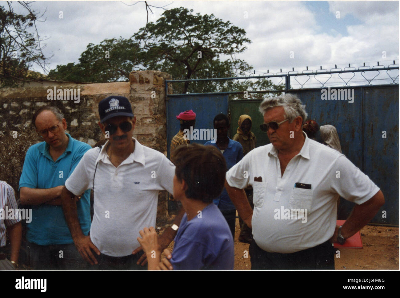 MEN STANDING AROUND Stock Photo - Alamy