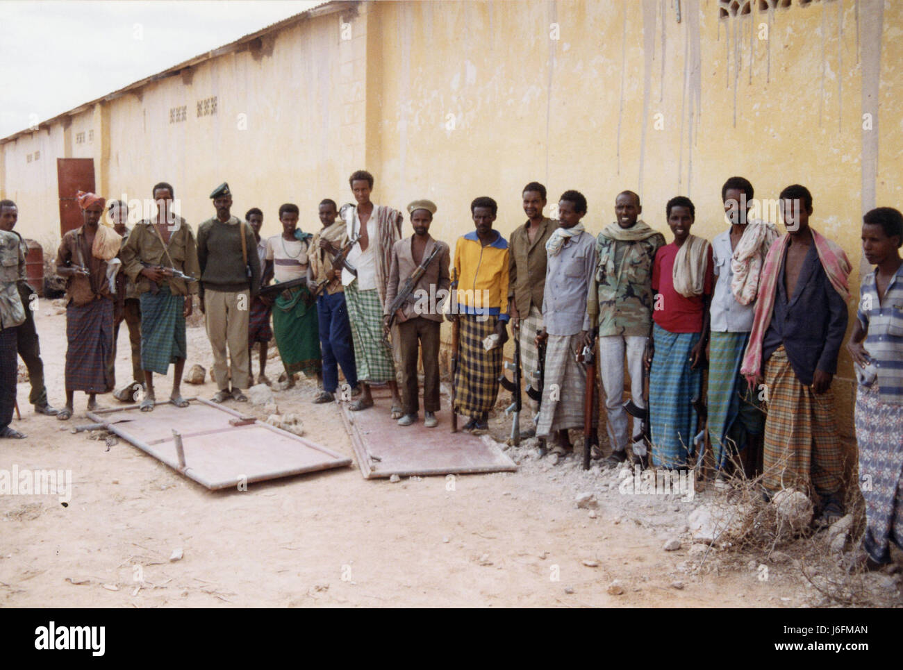 MEN STANDING IN LINE FOR PHOTO HOLDING GUNS Stock Photo - Alamy