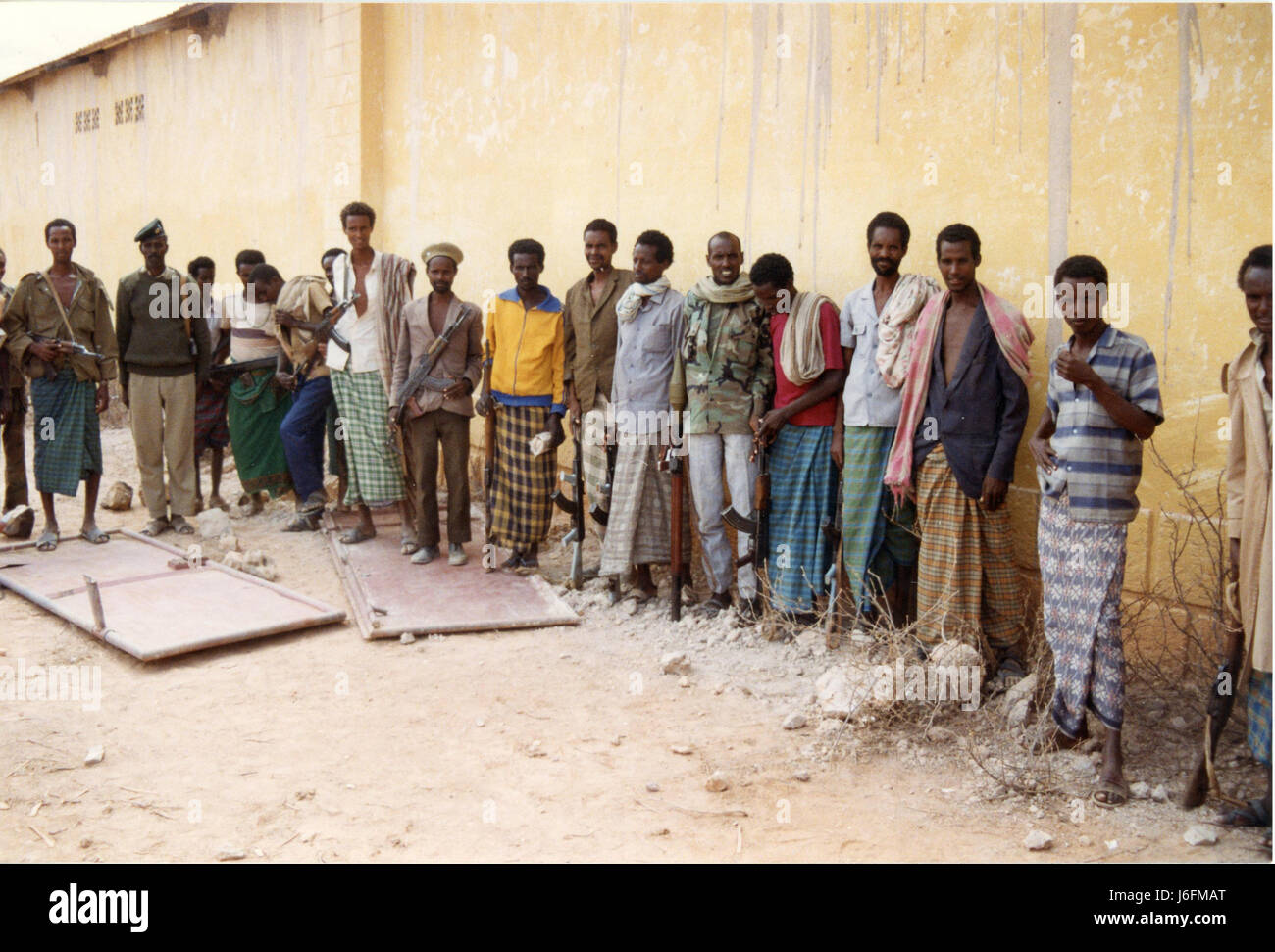 MEN STANDING IN LINE FOR PHOTO HOLDING GUNS Stock Photo - Alamy