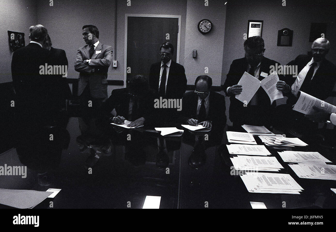 men sitting and standing around having side conversations Stock Photo ...