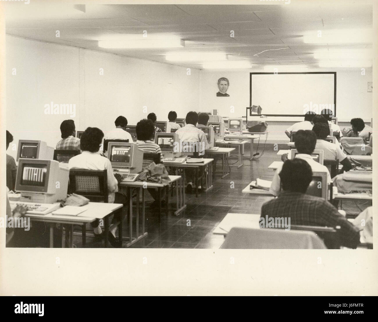 women and men sitting at computers Stock Photo - Alamy