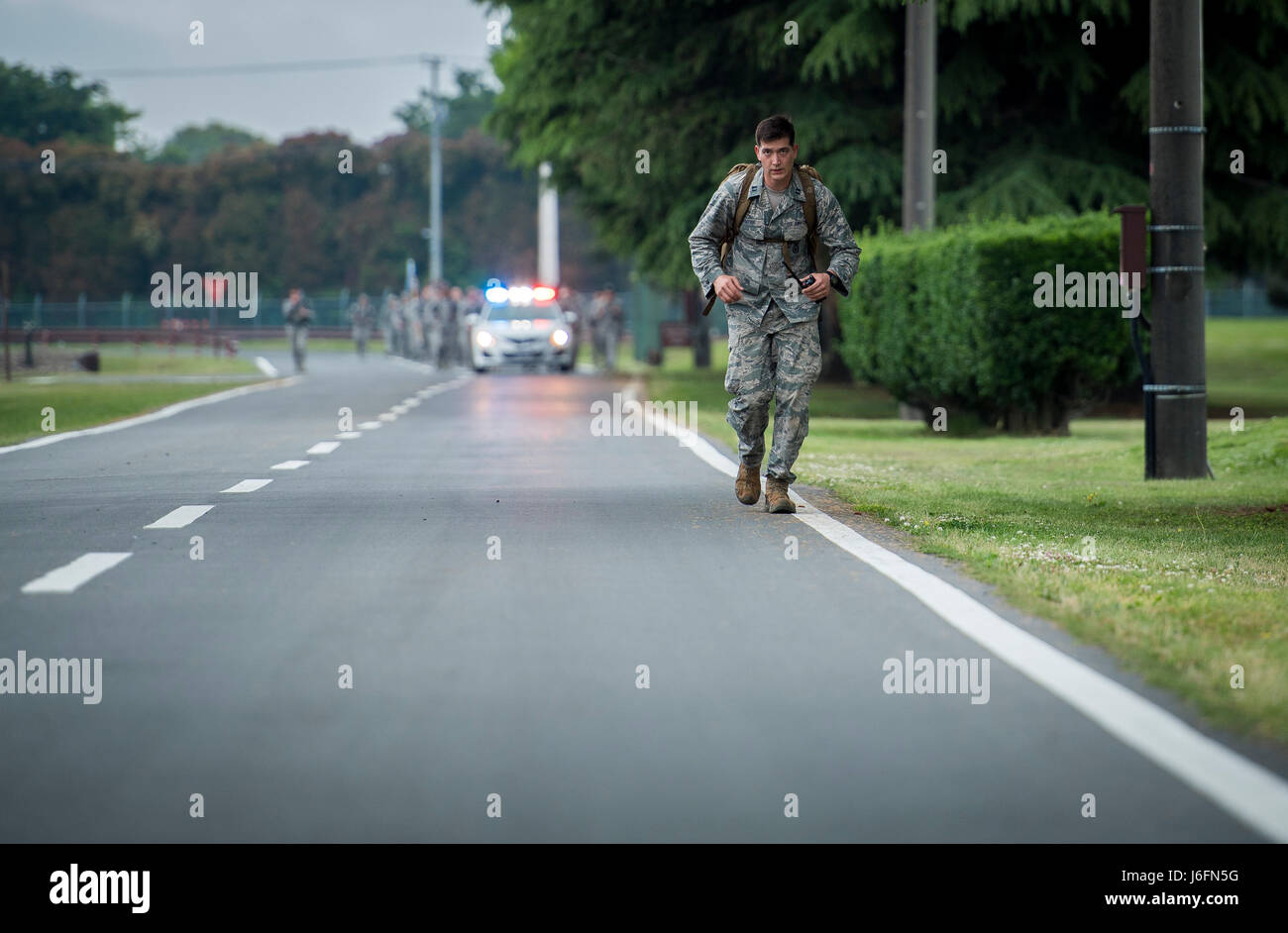A 374th Security Forces Squadron officer runs ahead of the group during ...