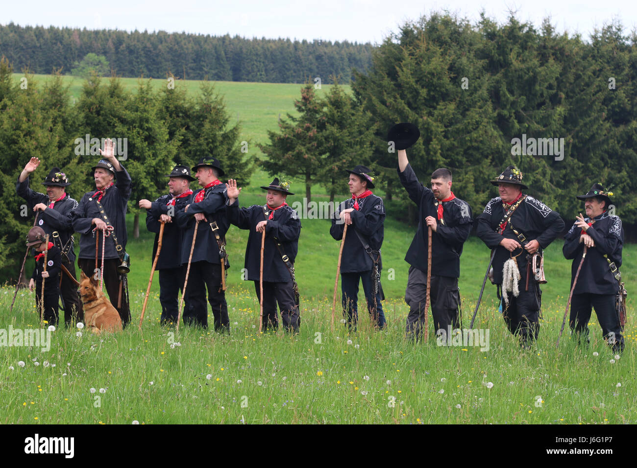 Tanne, Germany. 21st May, 2017. Cow owners stand on a lawn after the ...
