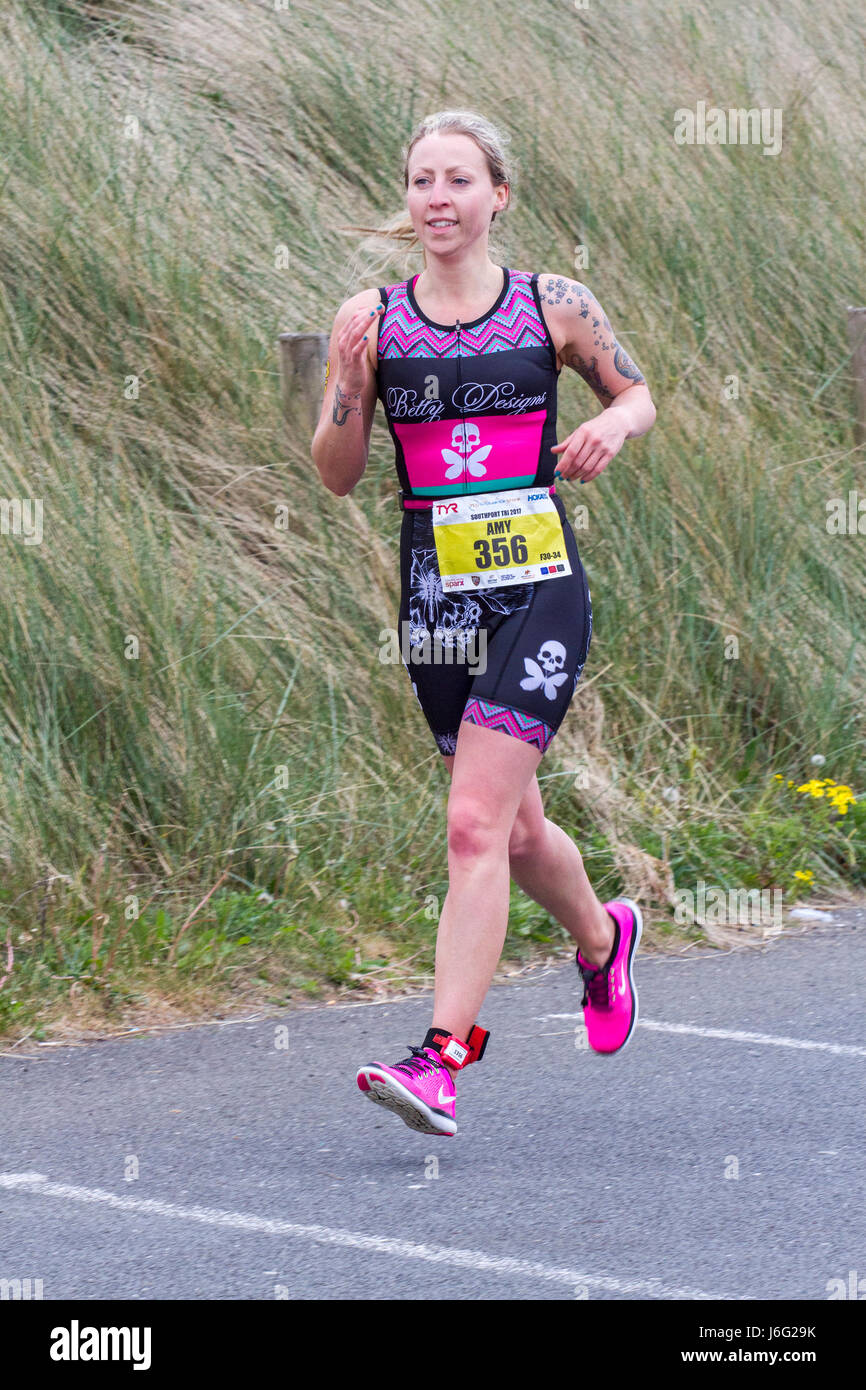 A female runner competing in a triathlon event in Southport, Merseyside ...