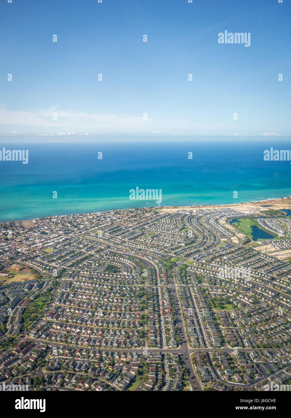 An aerial shot of Hawaiian suburbs, showing rows and rows of houses ...