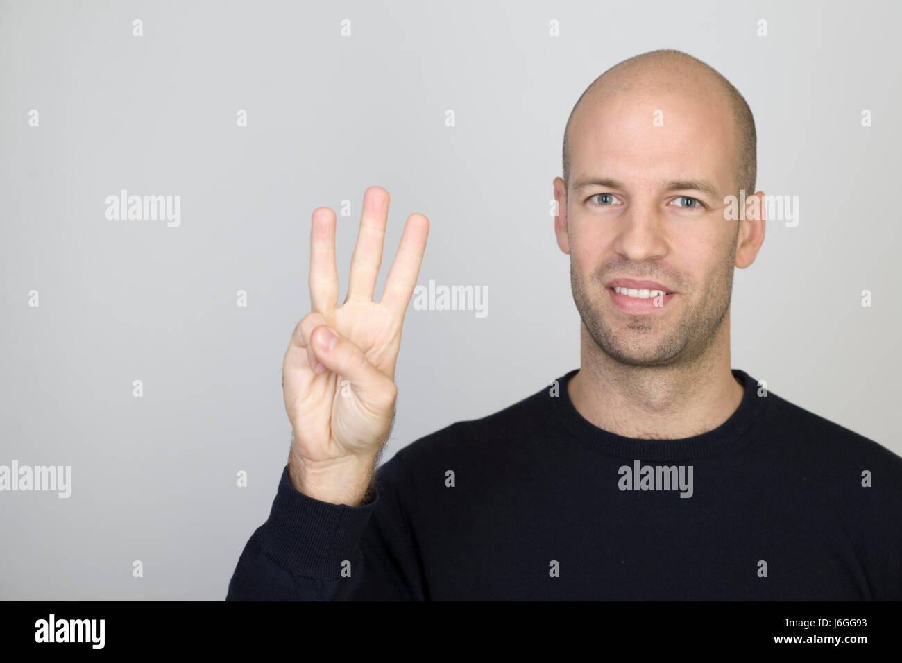 man showing three fingers the number 3 Stock Photo - Alamy