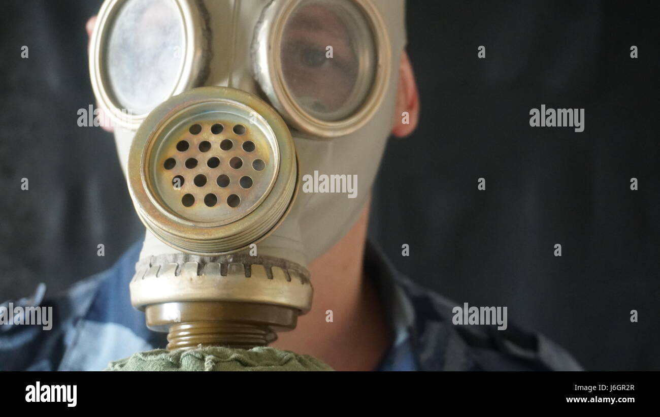Guard dressed in military uniform in a gas mask Stock Photo - Alamy