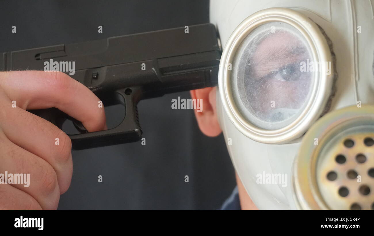 Guard dressed in military uniform in a gas mask Stock Photo - Alamy