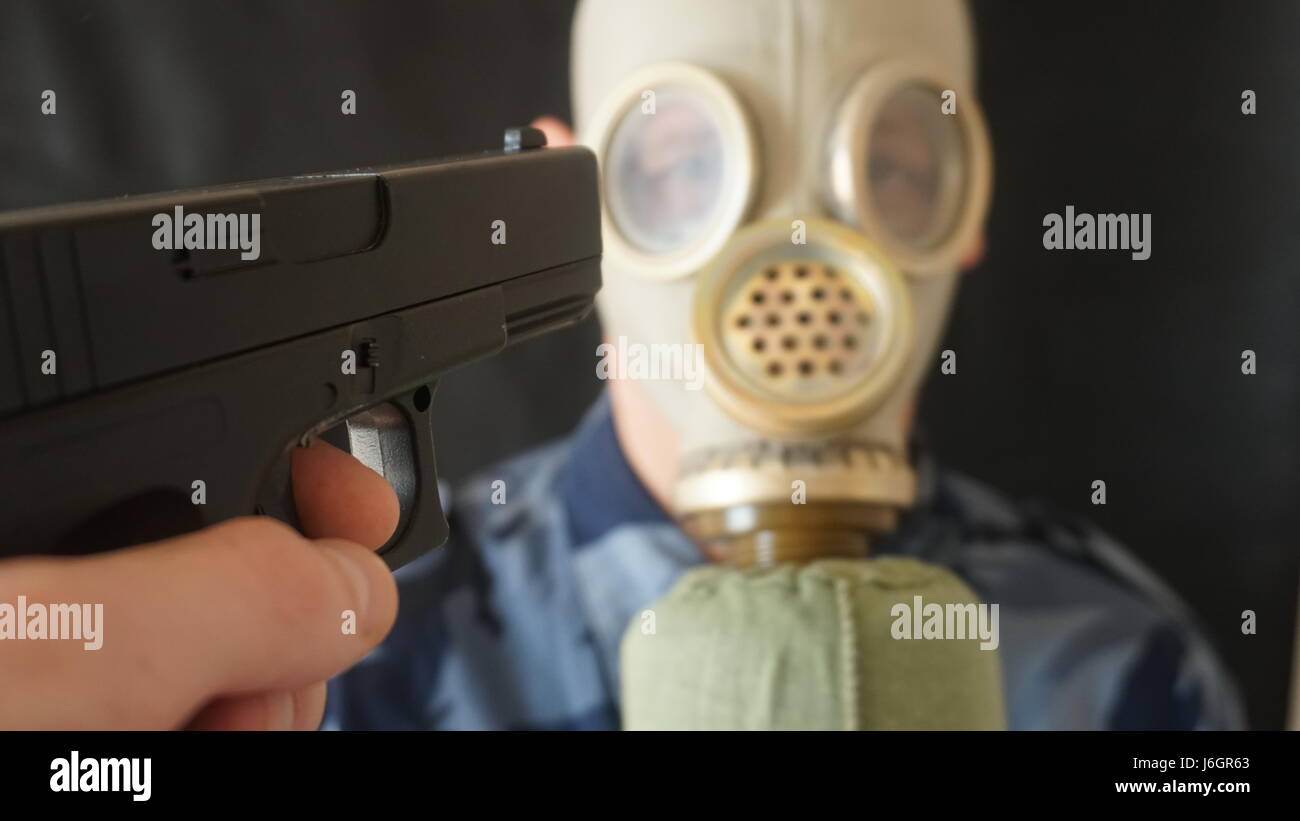 Guard dressed in military uniform in a gas mask Stock Photo - Alamy