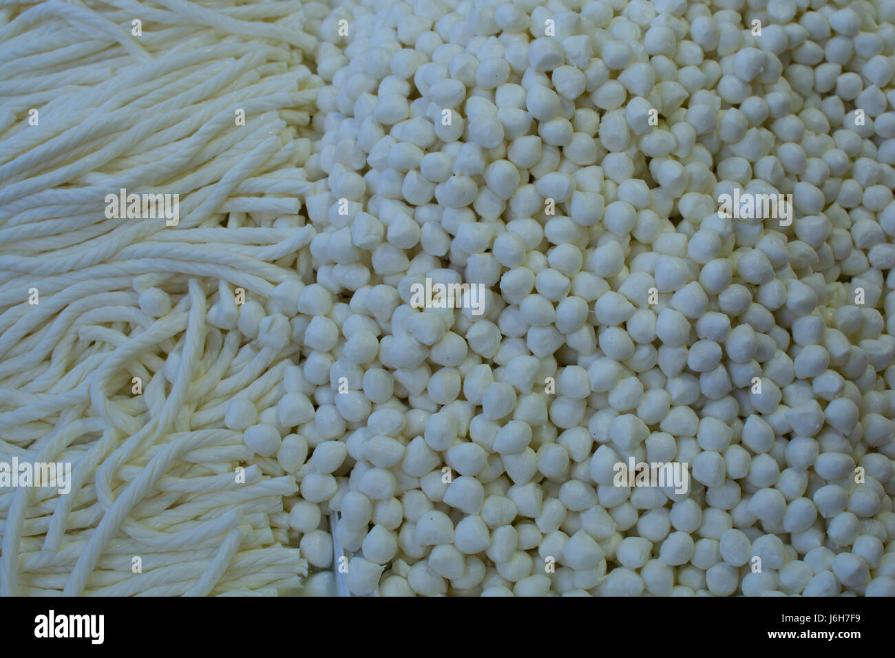 Wire mesh and drop shaped cheese grains Stock Photo - Alamy