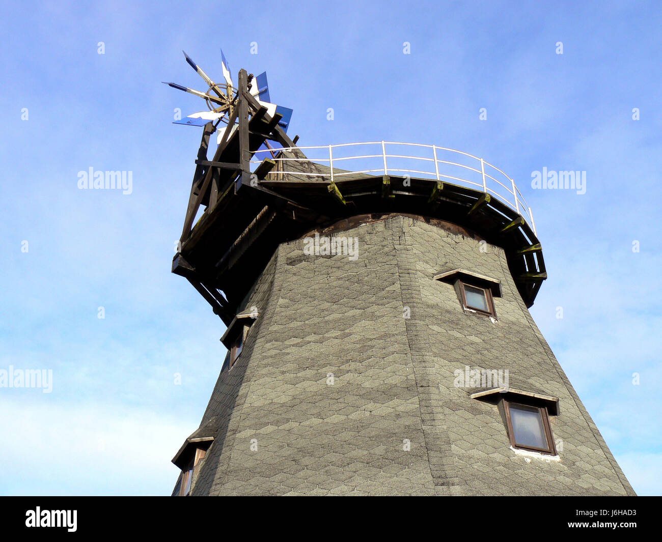 windmill wind energy wind rose pinwheel blue historical monument window ...