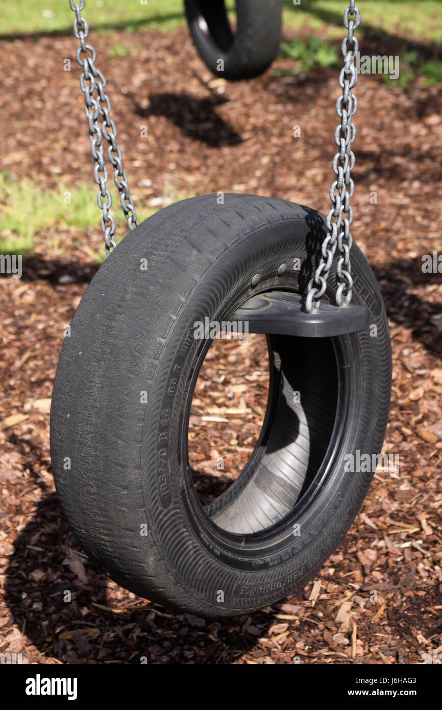 tire swing on a children's playground Stock Photo - Alamy