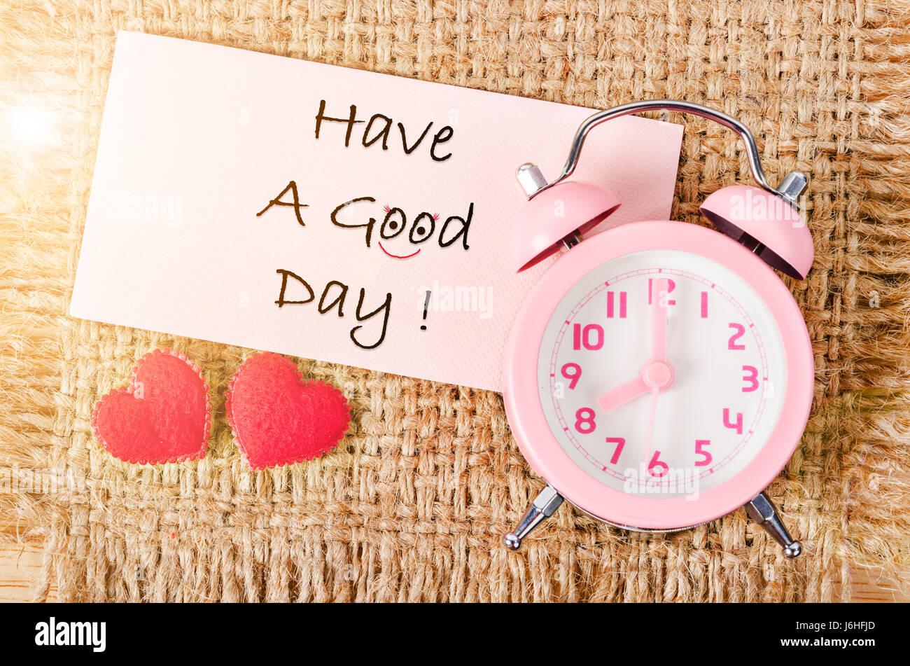 Have a good day card with pink vintage alarm clock Stock Photo - Alamy