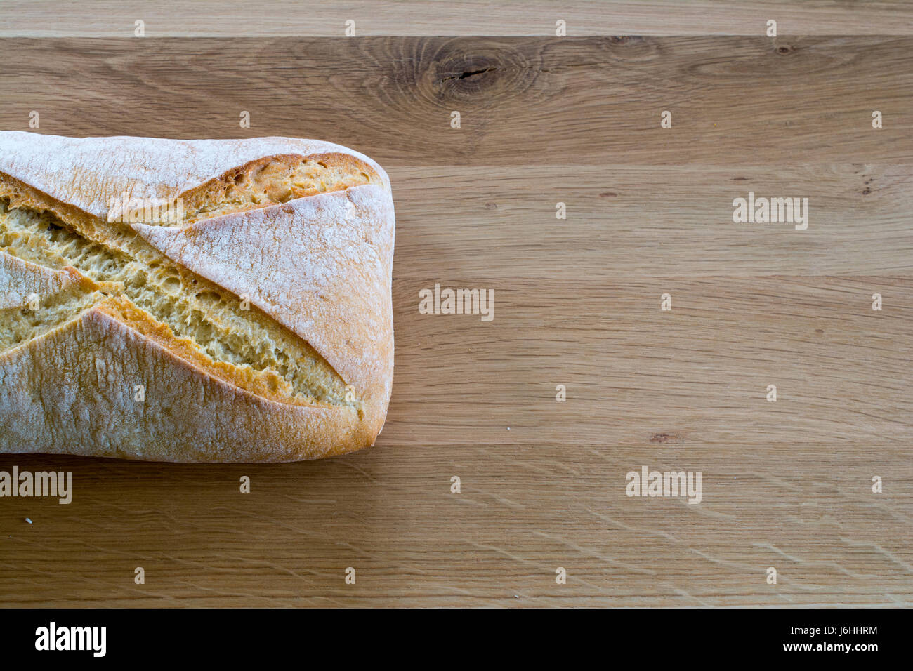 Fresh loaf of bread on wooden oak table top. Space for text Stock Photo ...