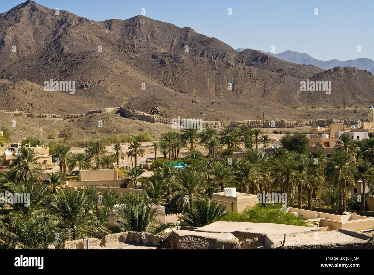 city town mountains city wall arabia oman blue house building houses ...