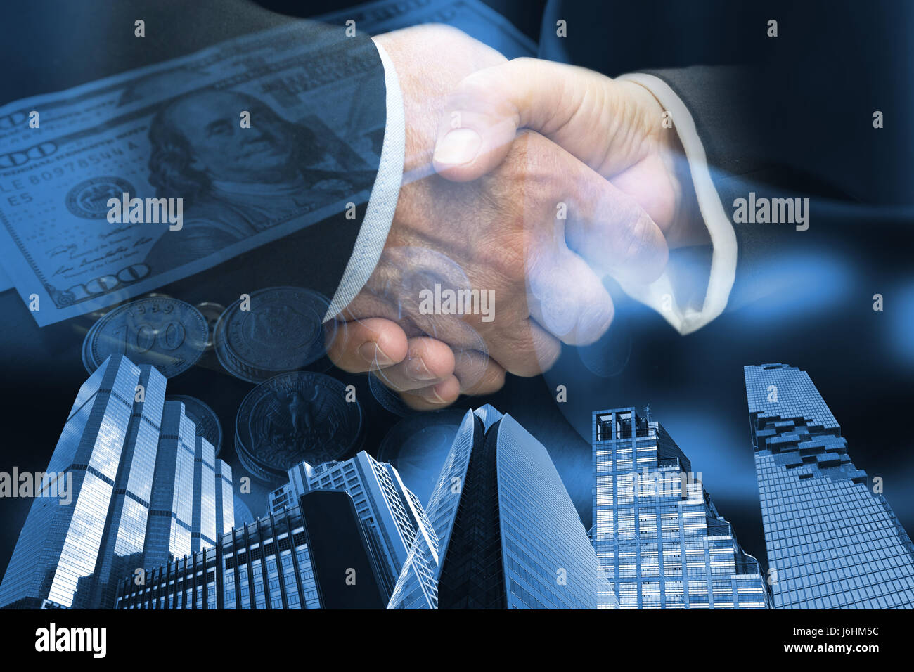 Two Business people shaking hands and abstract blue tone of buildings ...