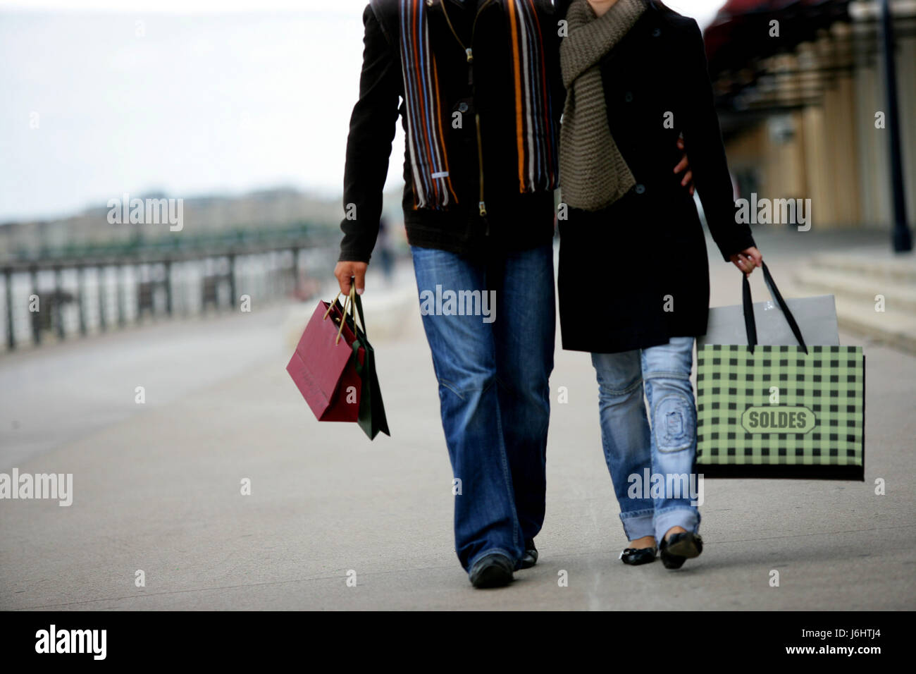 woman walk go going walking winter shopping outside front view bags ...