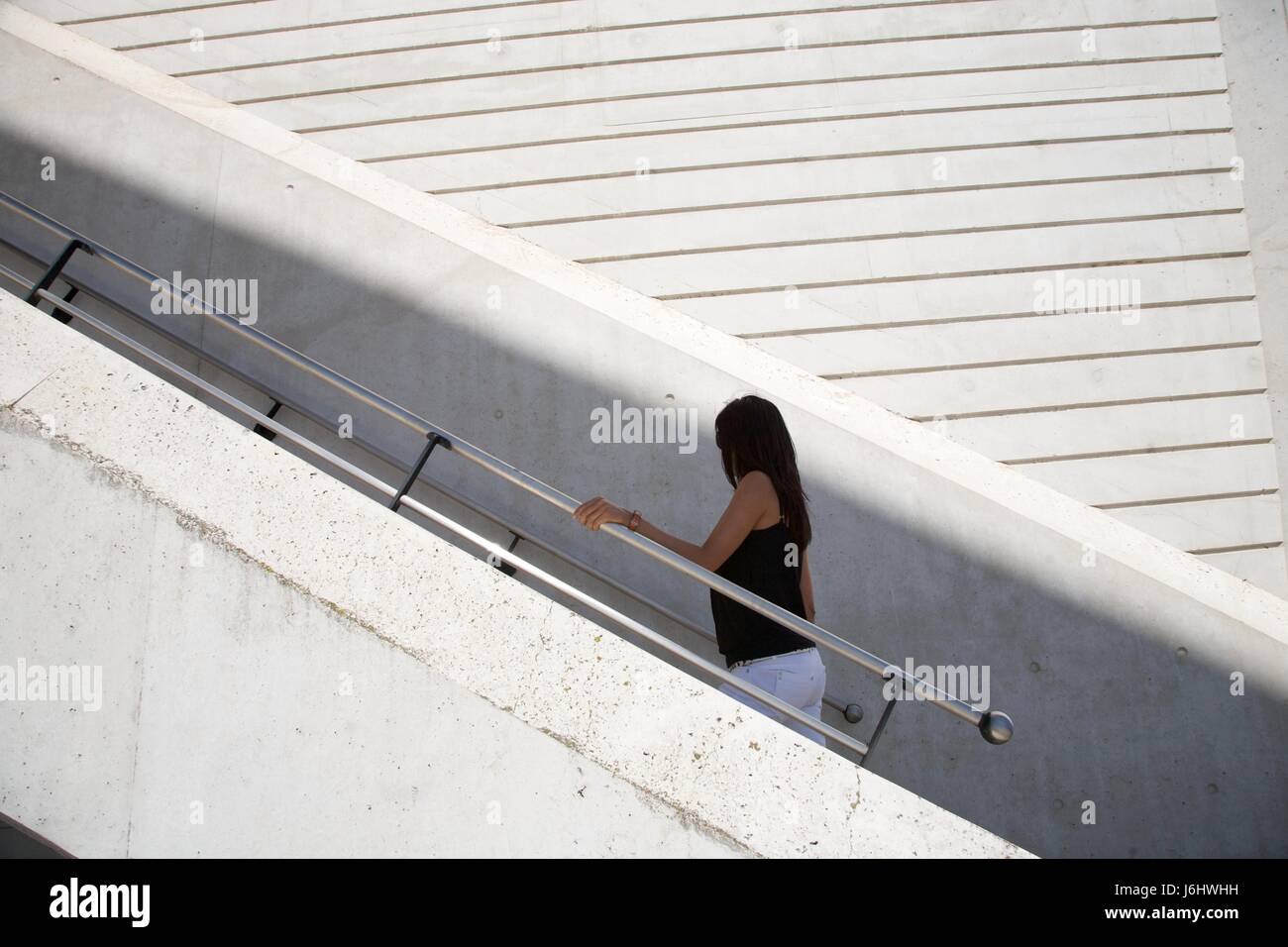 woman stairs walk go going walking lifestyle upstairs wall white woman ...