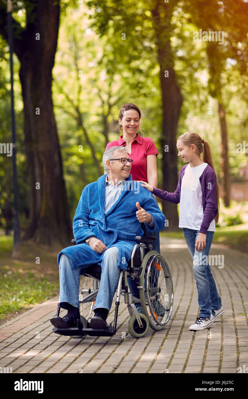 cheerful daughter and grandchildren visiting senior disabled father in ...