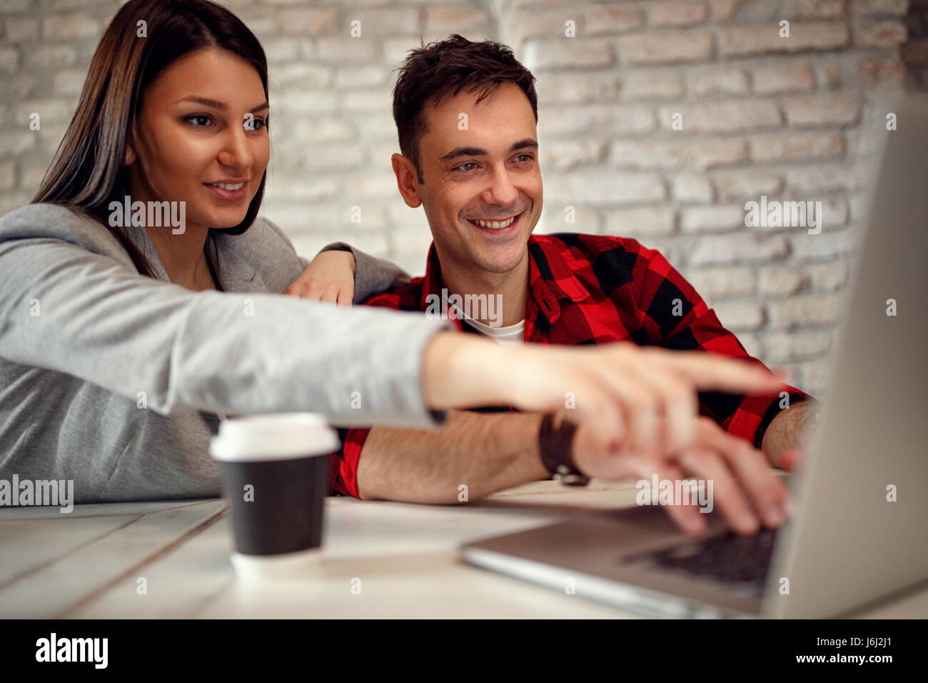 happy creative couple designers working in the office Stock Photo - Alamy