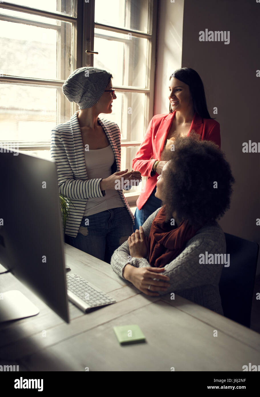 Female group chat in office Stock Photo - Alamy
